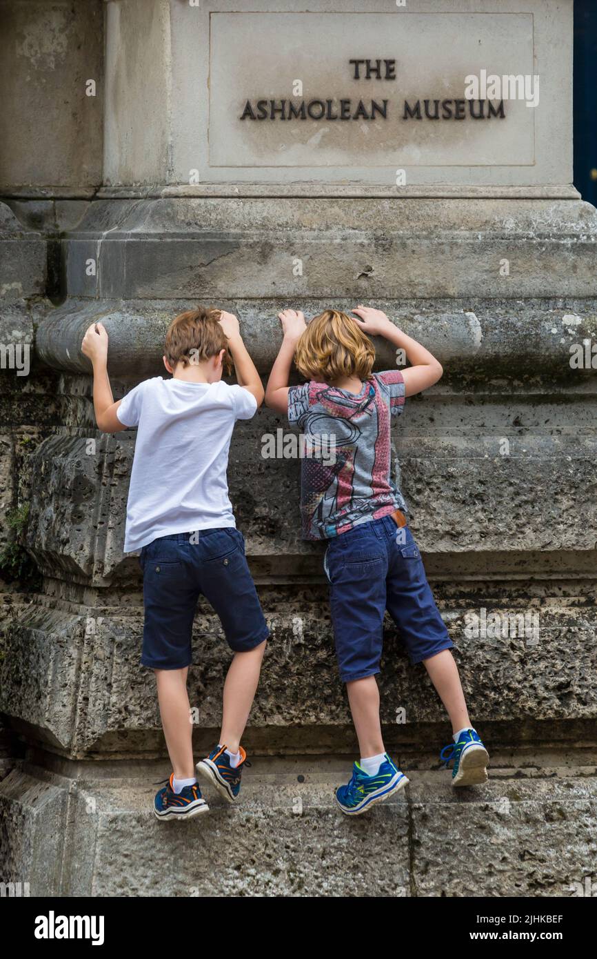 Two boys in front of the Ashmolean Museum at Oxford, Oxfordshire UK on ...