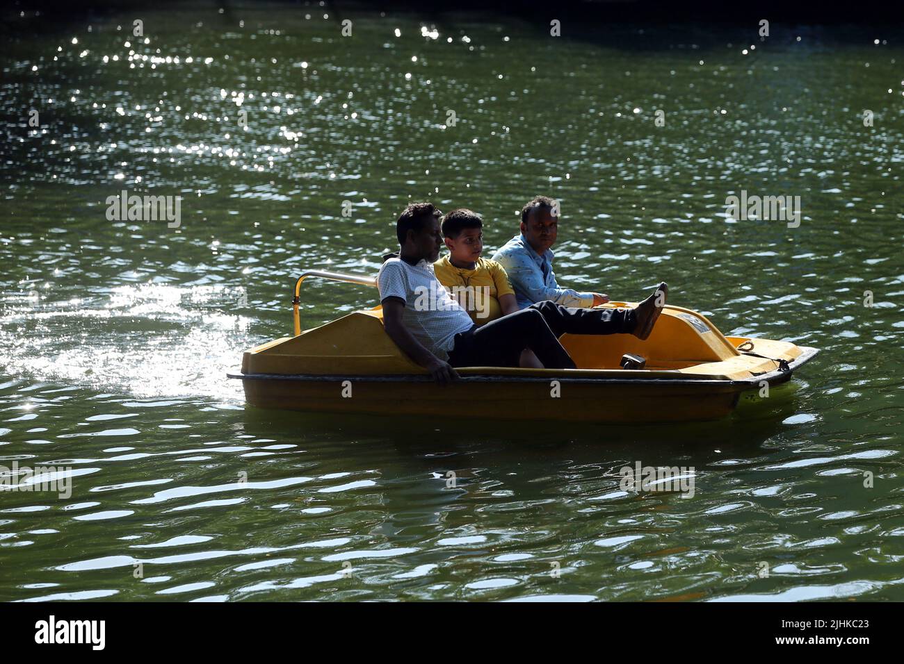 People along with their family and friends enjoying boat riding on ...