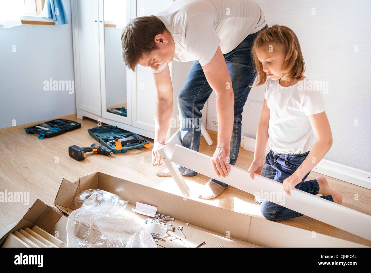 Dad,little girls daughters assemblle wooden baby bed according to ...