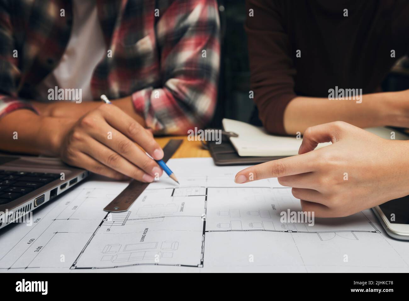 Group of two coworkers working with blueprint in office. co-working ...