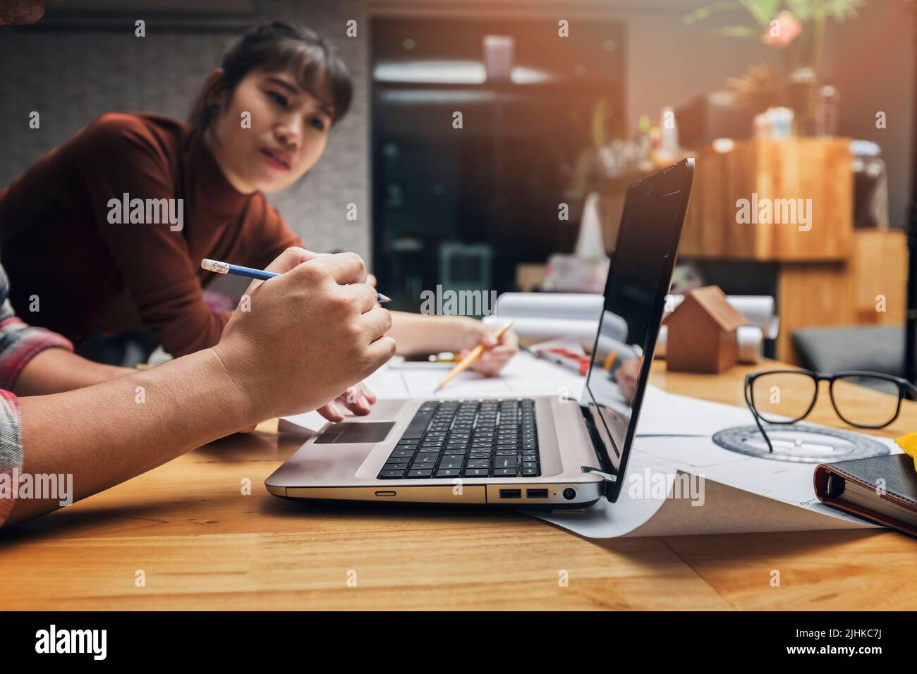 Group of two coworkers working with blueprint in office. co-working ...