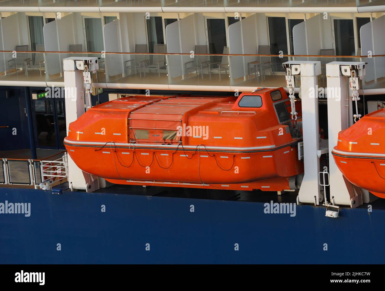 Lifeboats hanging over deck on cruise ship Stock Photo - Alamy
