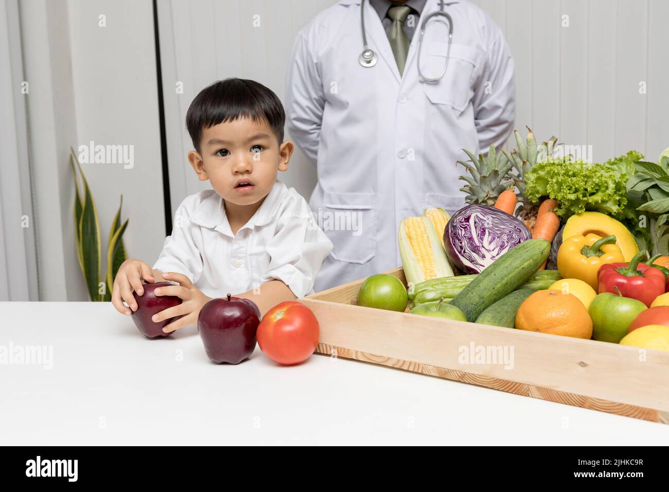 A boy and doctor happy to have healthy food. Kid learning about ...
