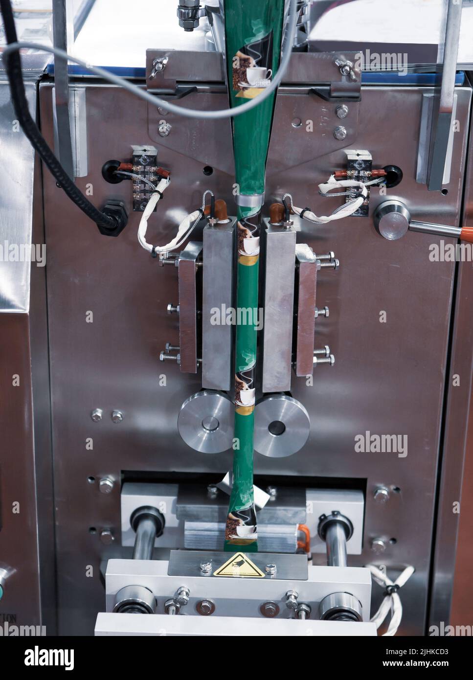 Ground coffee filling in sachet on vertical package filling machine ...