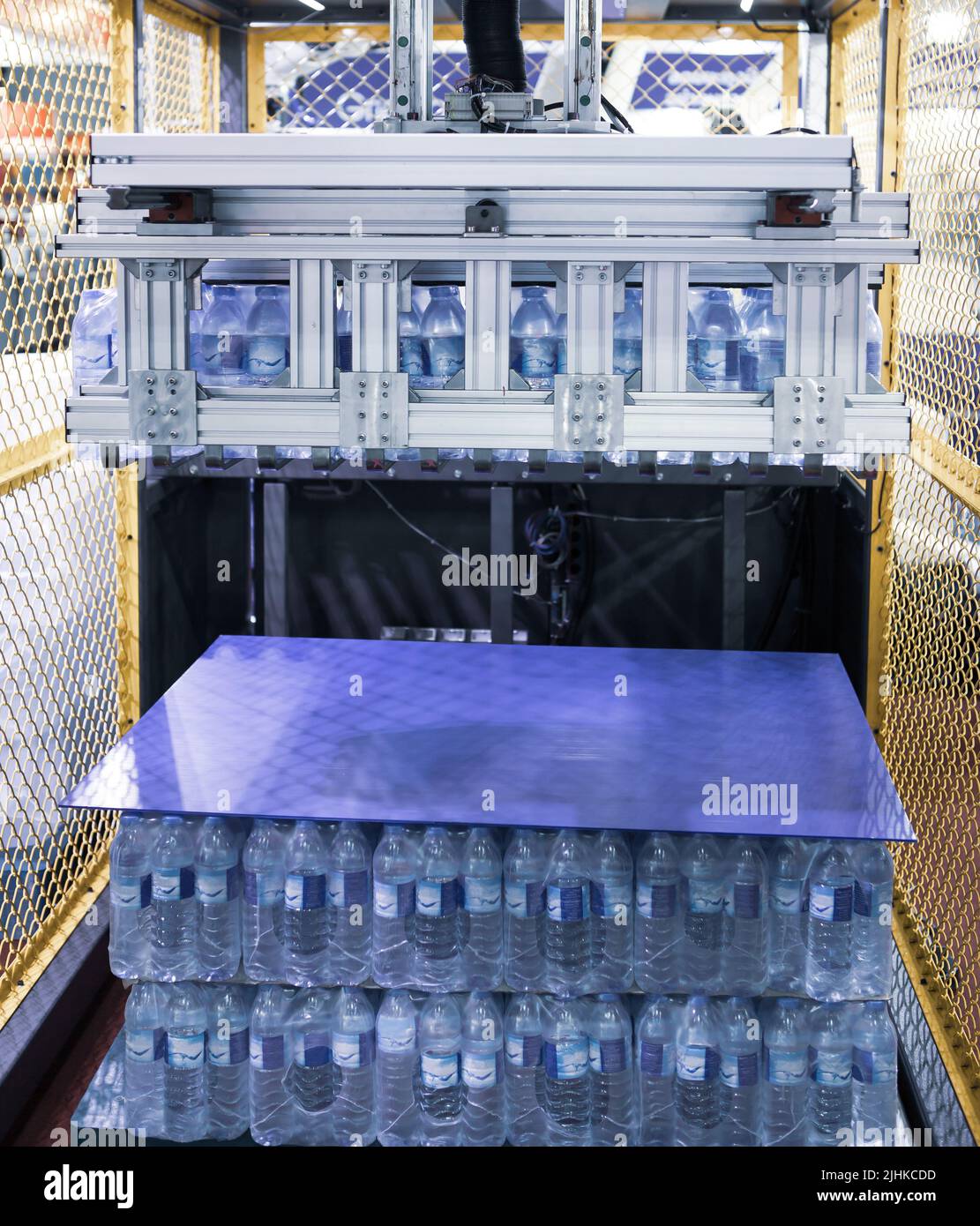 Robot arm lifting packages bottle of water in water bottling line Stock ...