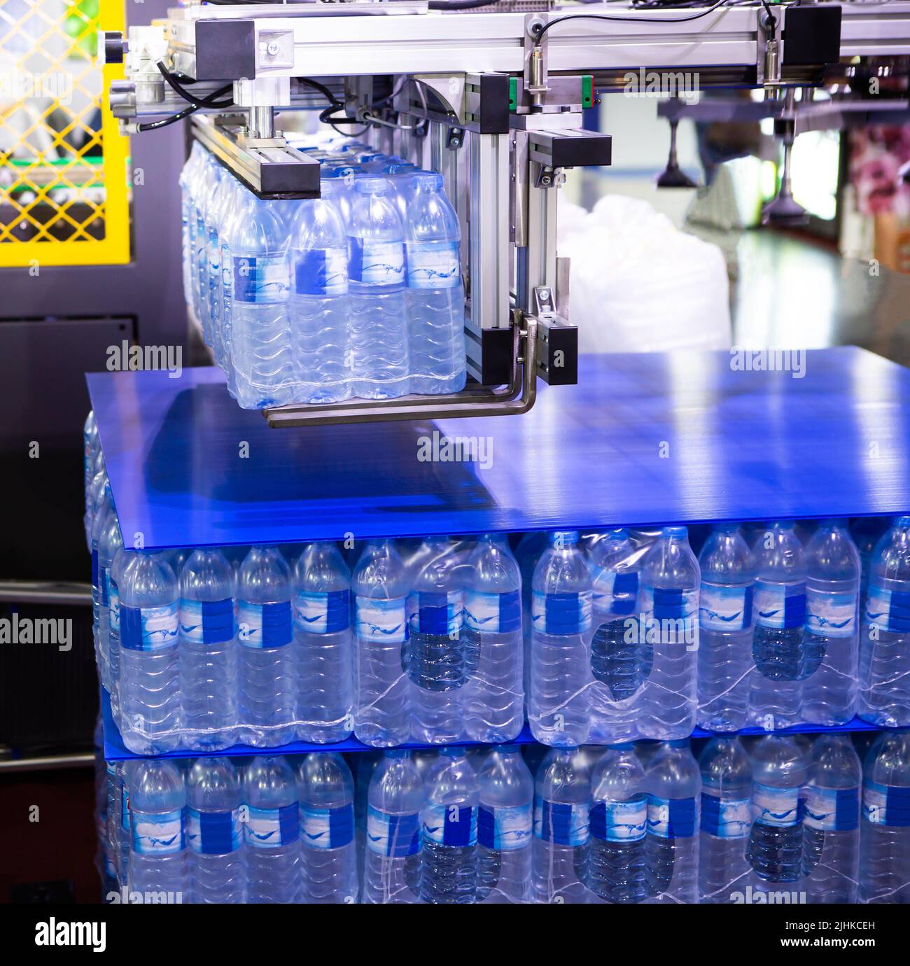 Robot arm lifting packages bottle of water in water bottling line Stock ...