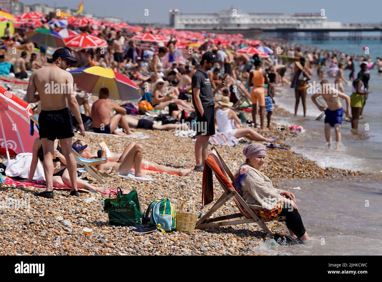 People on the beach in Brighton, East Sussex. Temperatures have reached ...