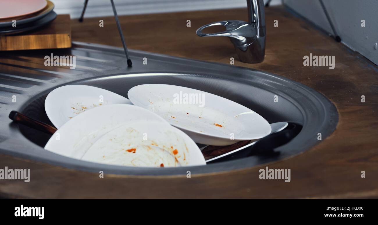 Dirty plates in the sink hi-res stock photography and images - Alamy