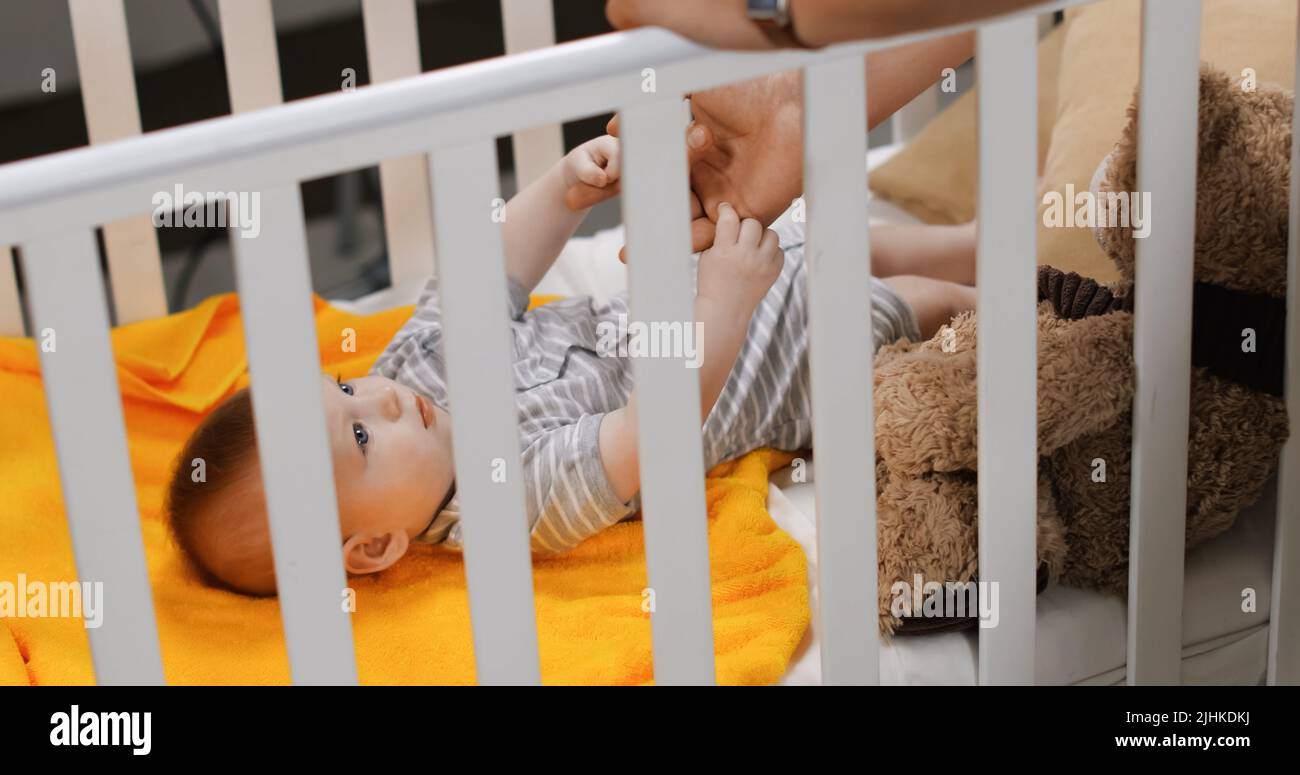 Baby holding hands teddy bear hi-res stock photography and images - Alamy