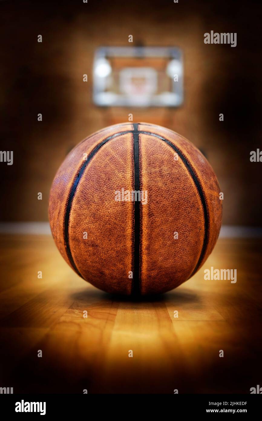 Basketball court with ball hoops rims hardwood floor and lights for ...