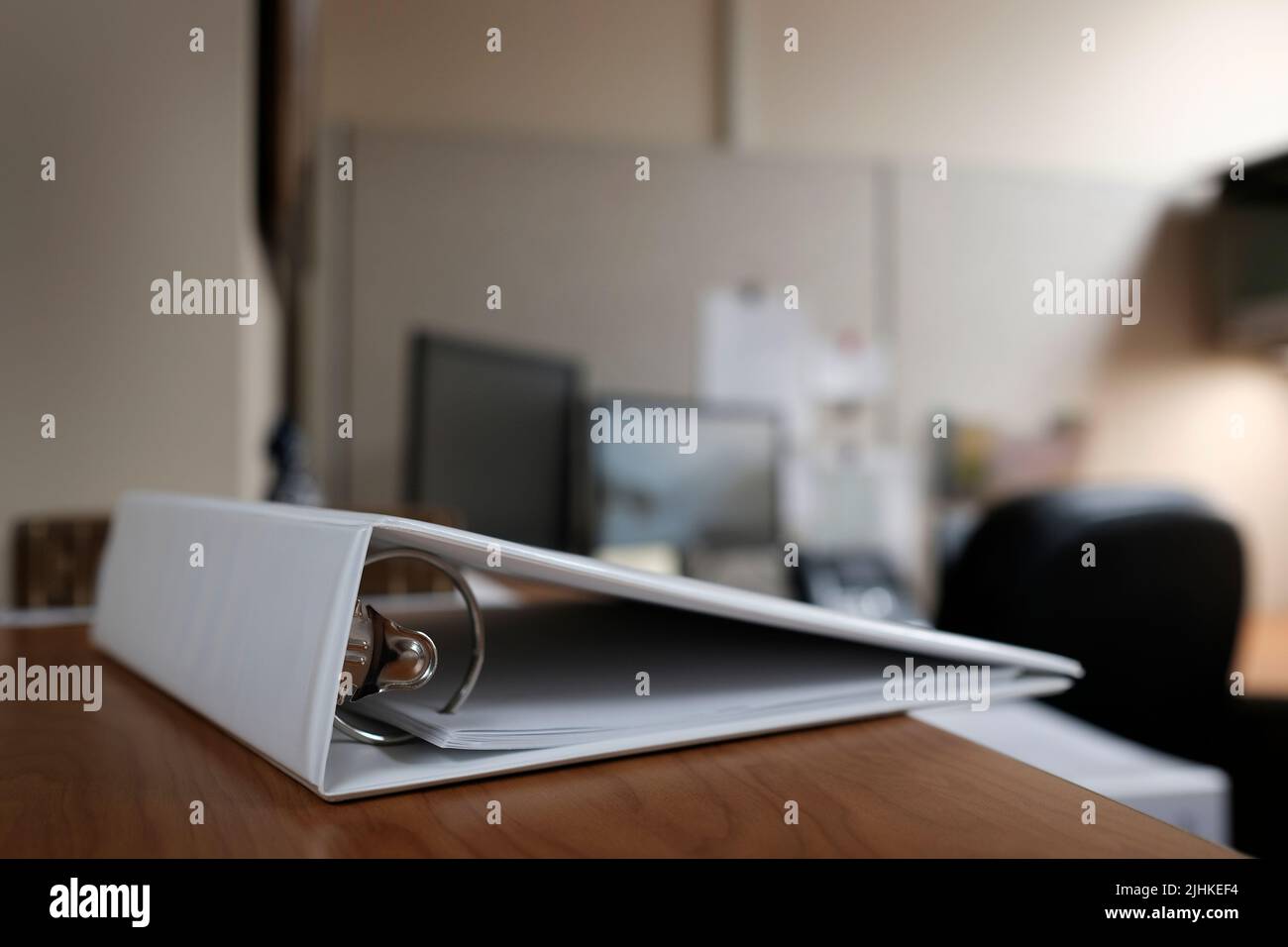 Binders on desk or shelves in an office for organizing business ...