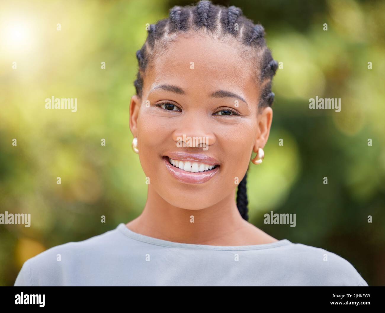 Smile, sunshine. a young woman spending time in nature Stock Photo - Alamy