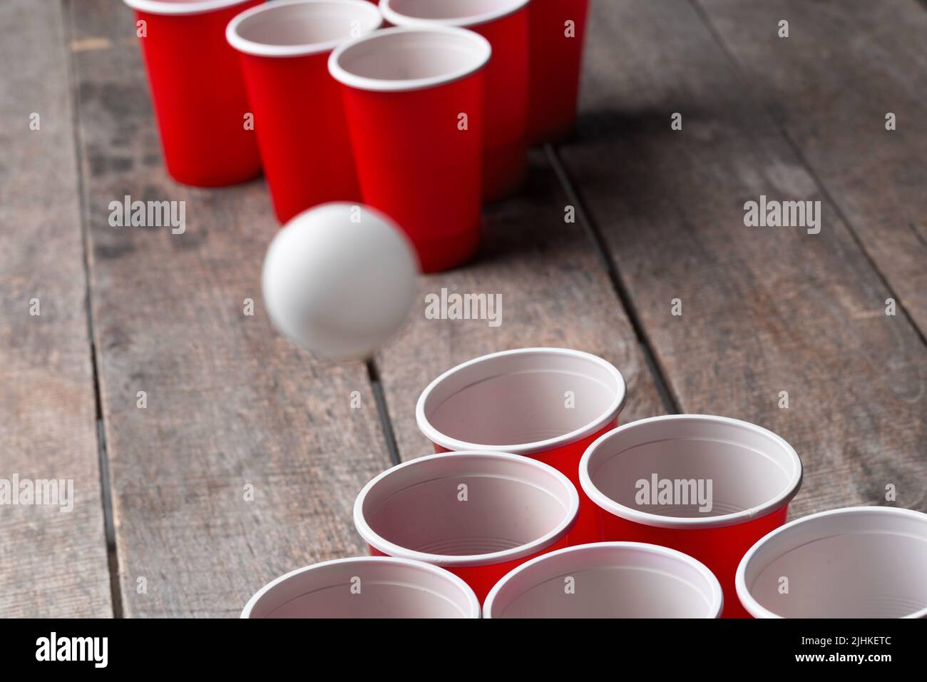 Game Beer Pong on wooden table Stock Photo - Alamy