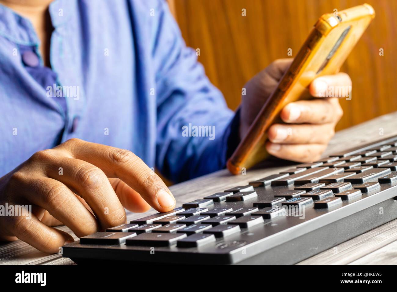Selective focus on an Indian male hand using mobile phone to enter one ...
