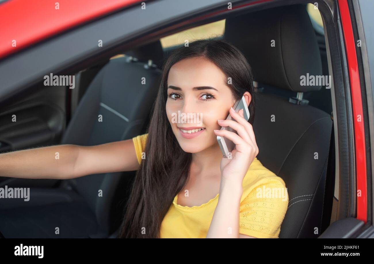 Woman is using a smartphone while driving a car Stock Photo - Alamy