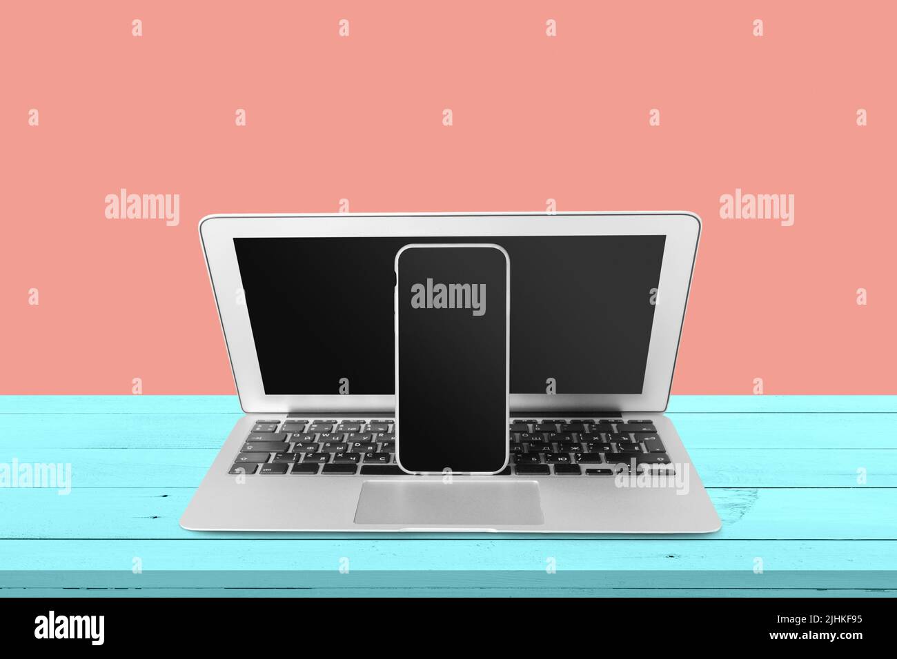 Laptop and mobile on the table Stock Photo - Alamy