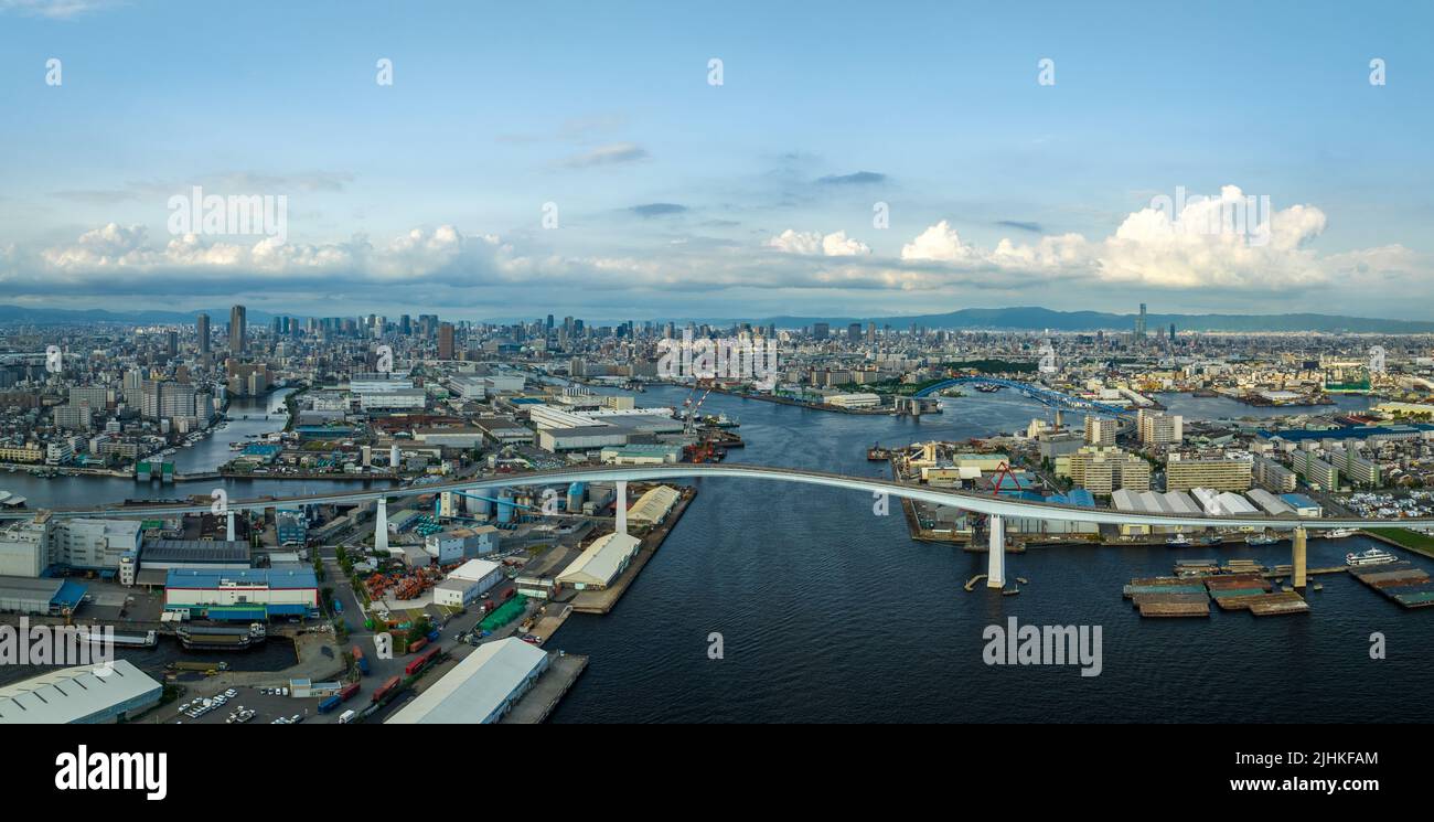 Panoramic view of bridge over river and sprawling city at sea level ...