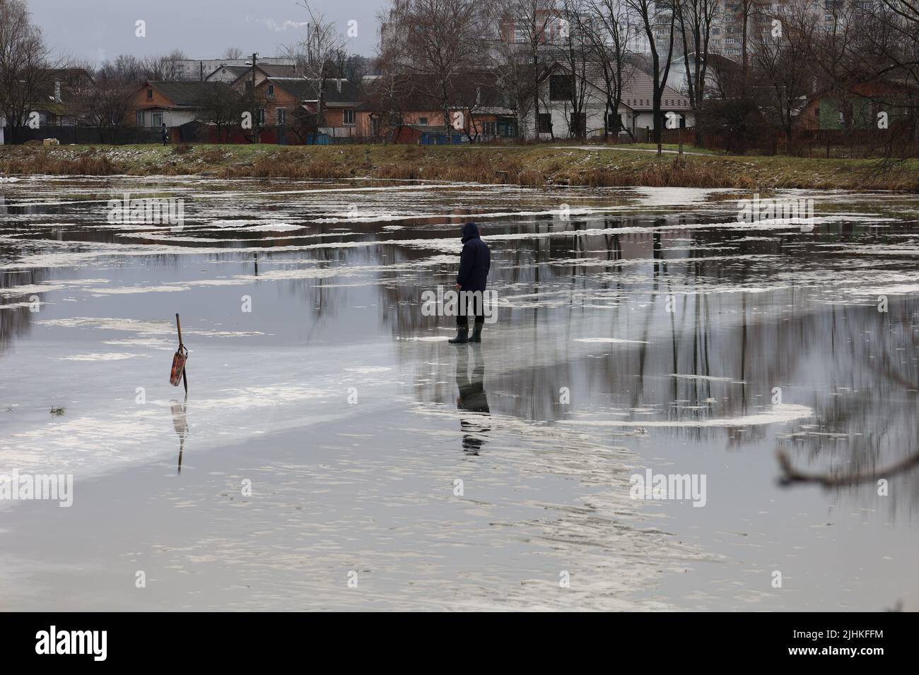 Fisherman stands on the river, spring, melts ice Stock Photo - Alamy