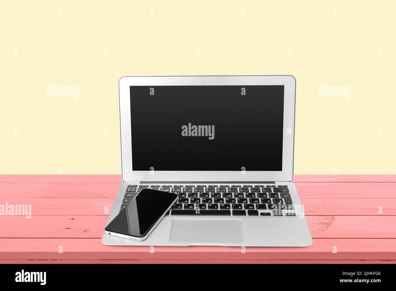 Laptop and mobile on the table Stock Photo - Alamy