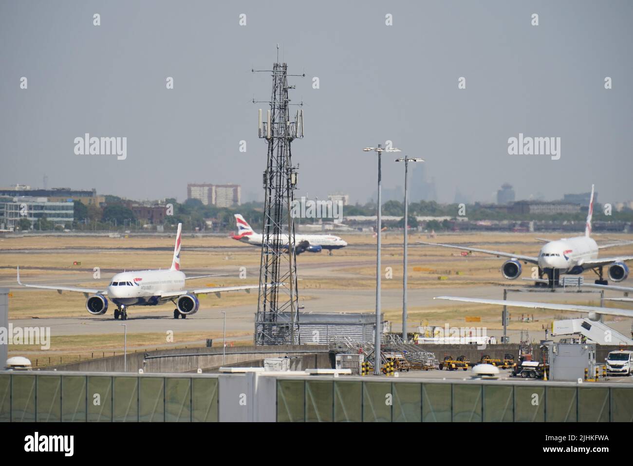 British Airways planes taxi through the heat haze at Heathrow Airport ...