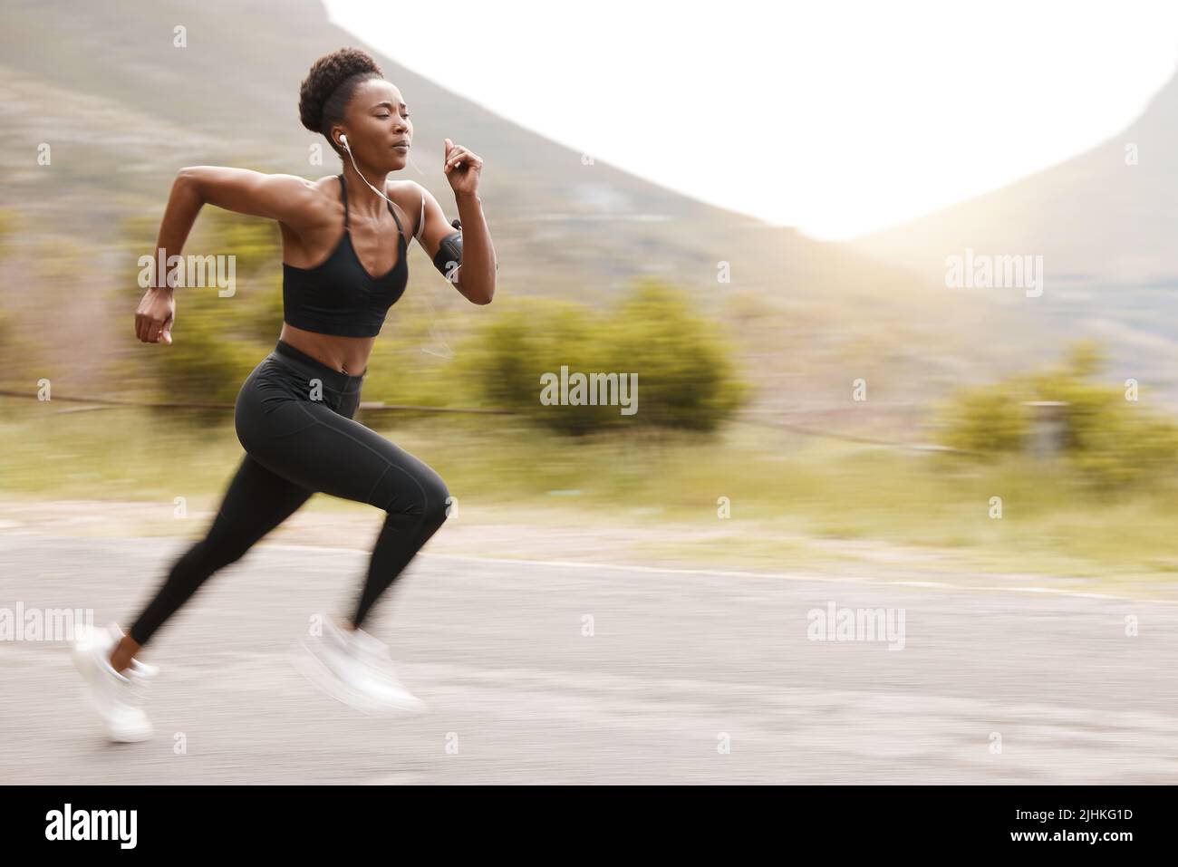 One african american female athlete looking focused while out for run ...