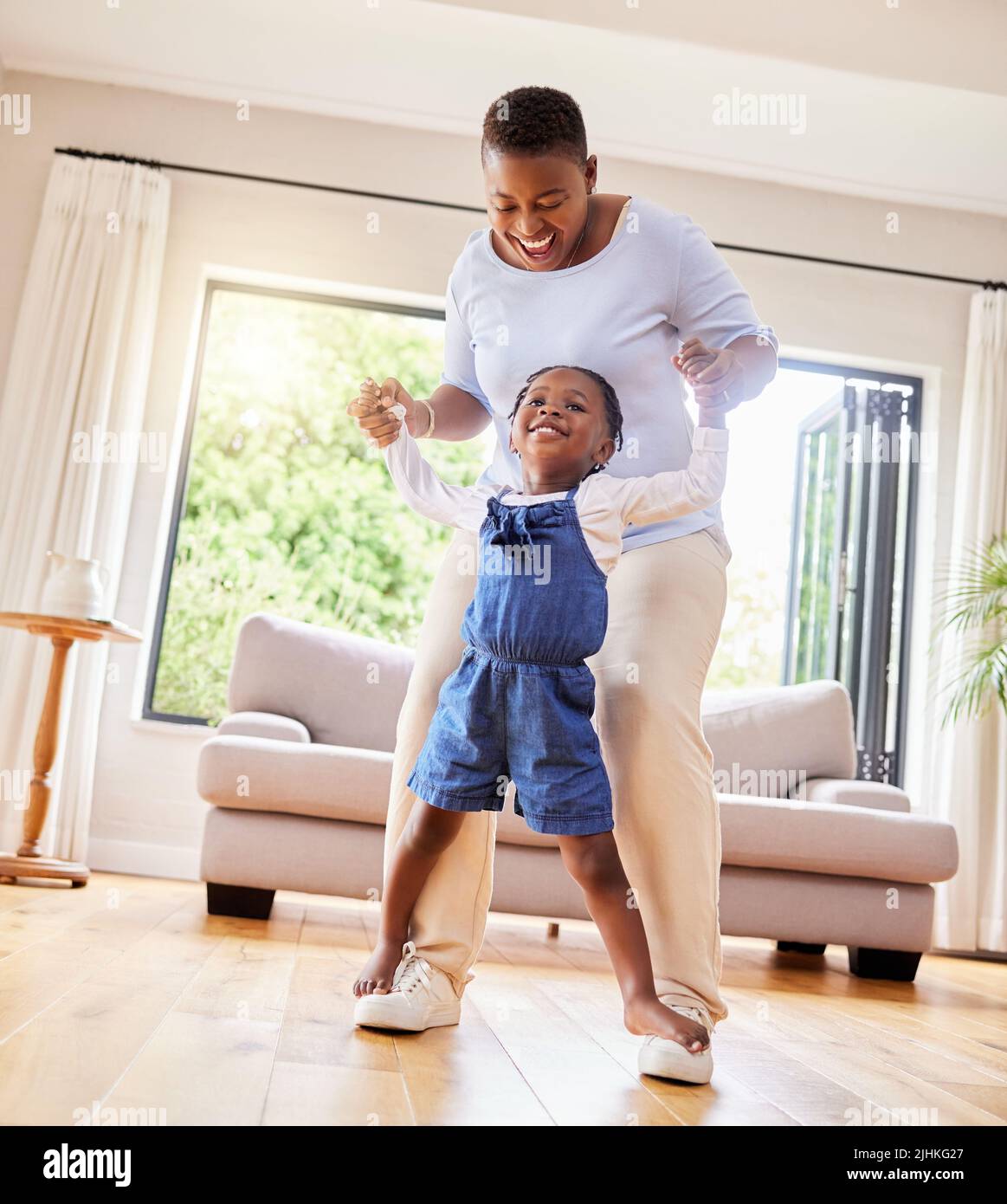 Ill teach you some moves. a mother and daughter dancing in the lounge ...