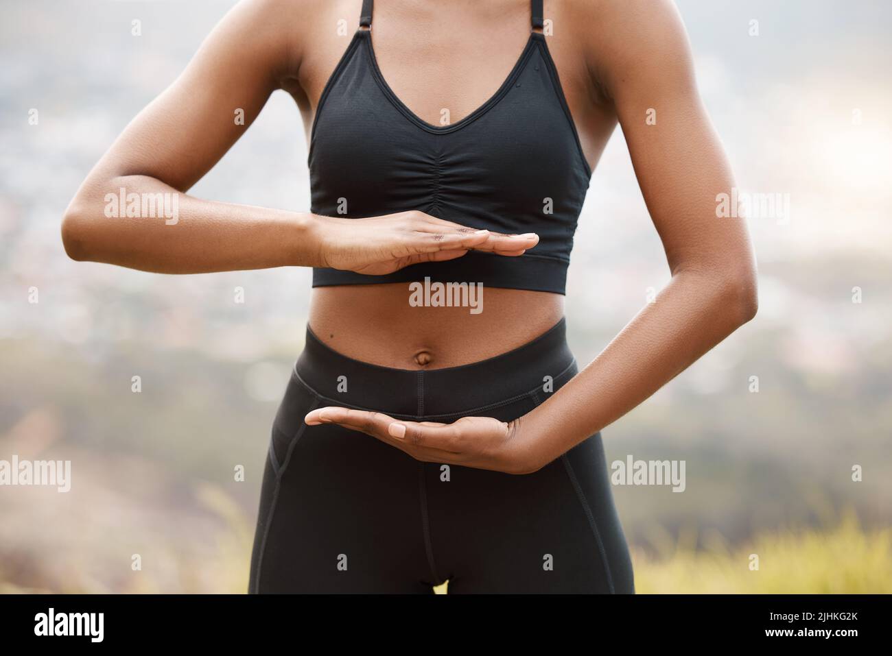 One african american female framing her stomach with her hands while ...