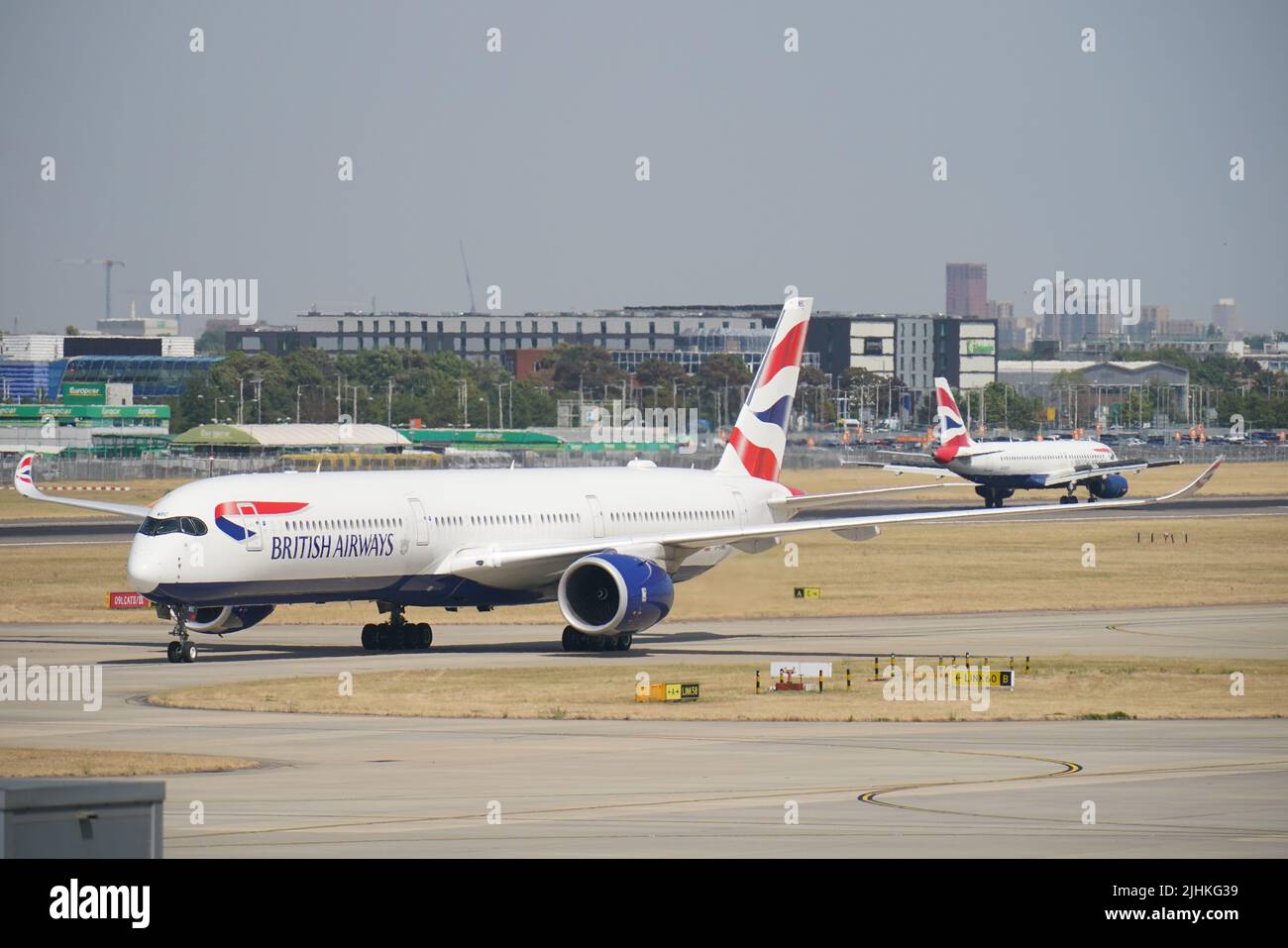British Airways planes taxi through the haze of heat at Heathrow ...