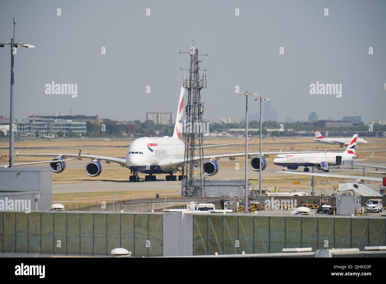British Airways planes taxi in the heat at Heathrow Airport, London ...