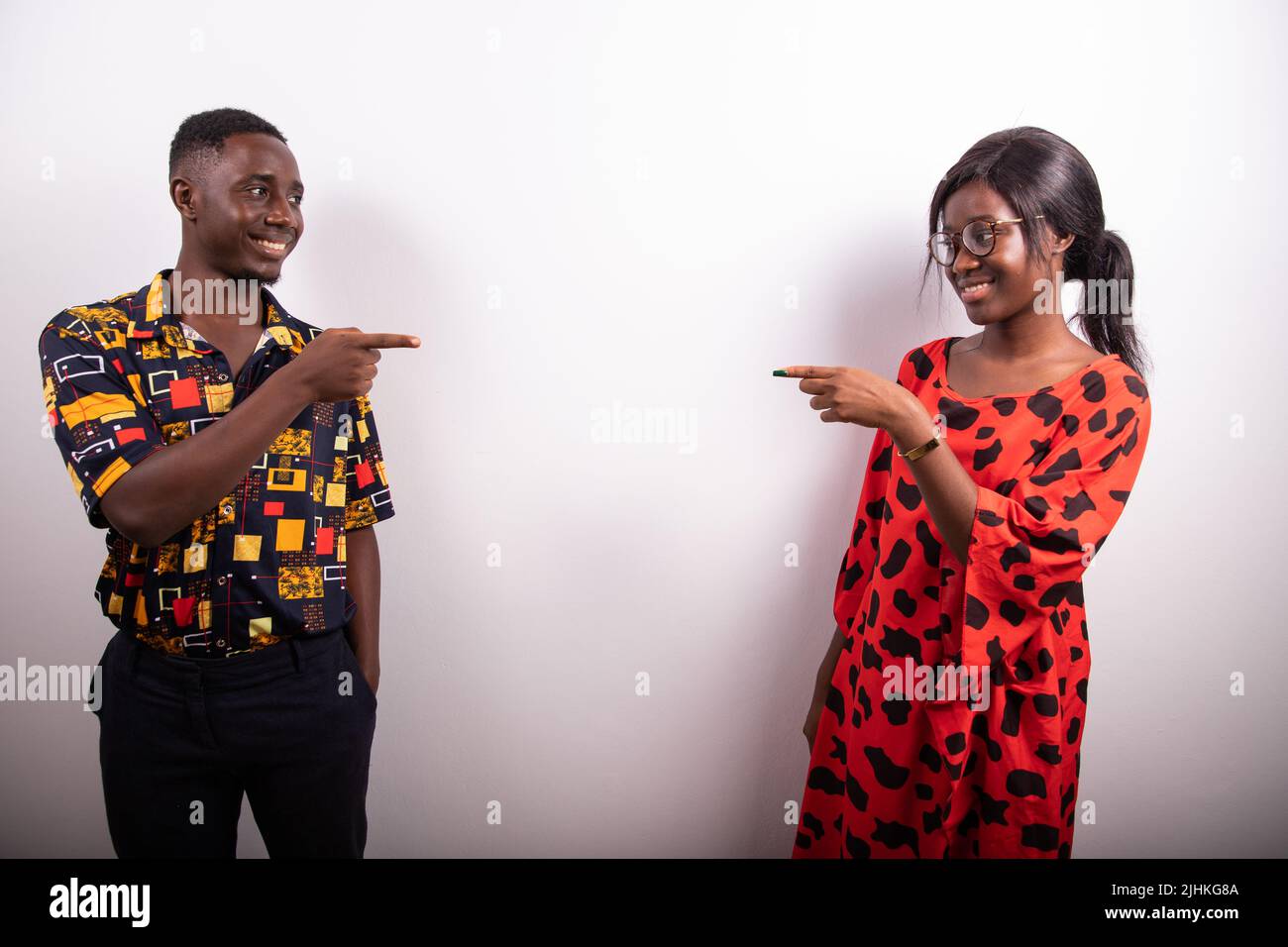 The guys, one on the left and the other on the right point with their ...