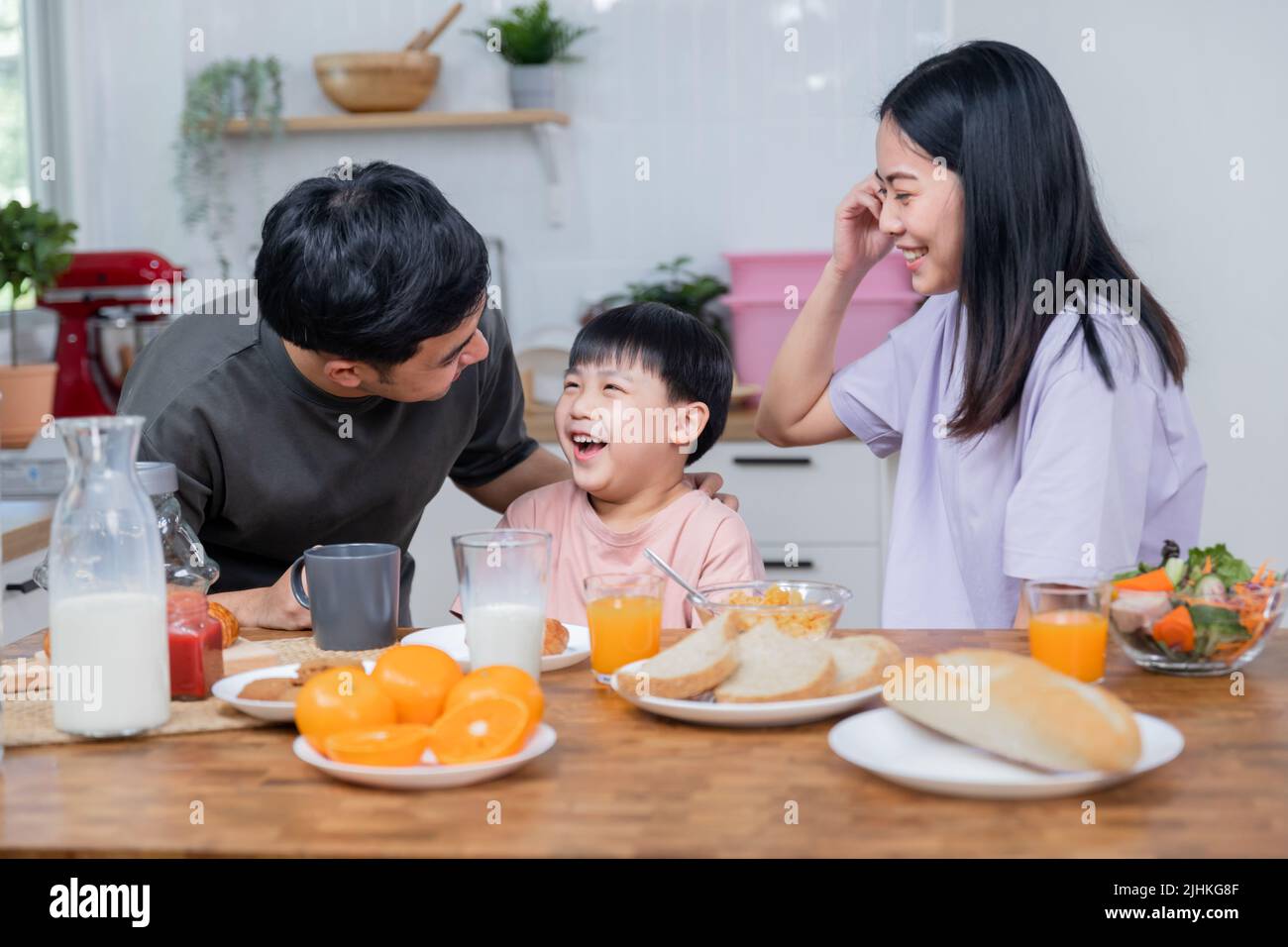 Happy Asian family, young boy eating healthy food together Stock Photo ...