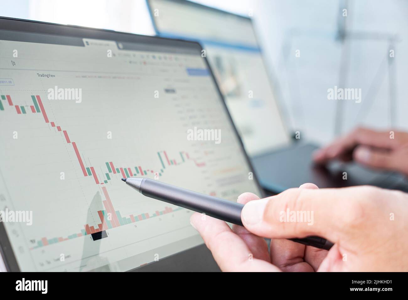 Human hand with stylus pen marking data point on computer screen ...
