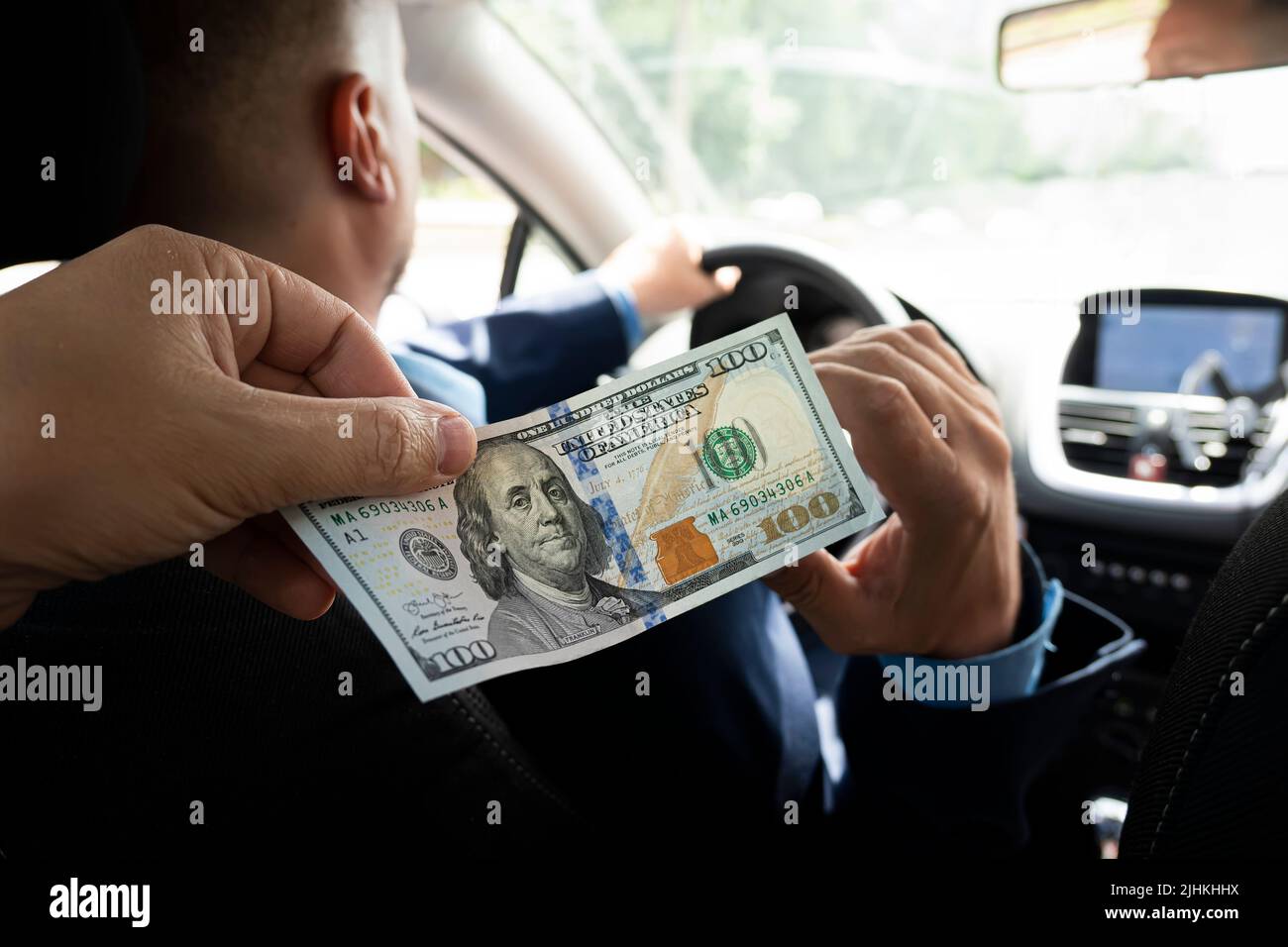 Passengers pay service fees to male taxi drivers. client pays for the ...