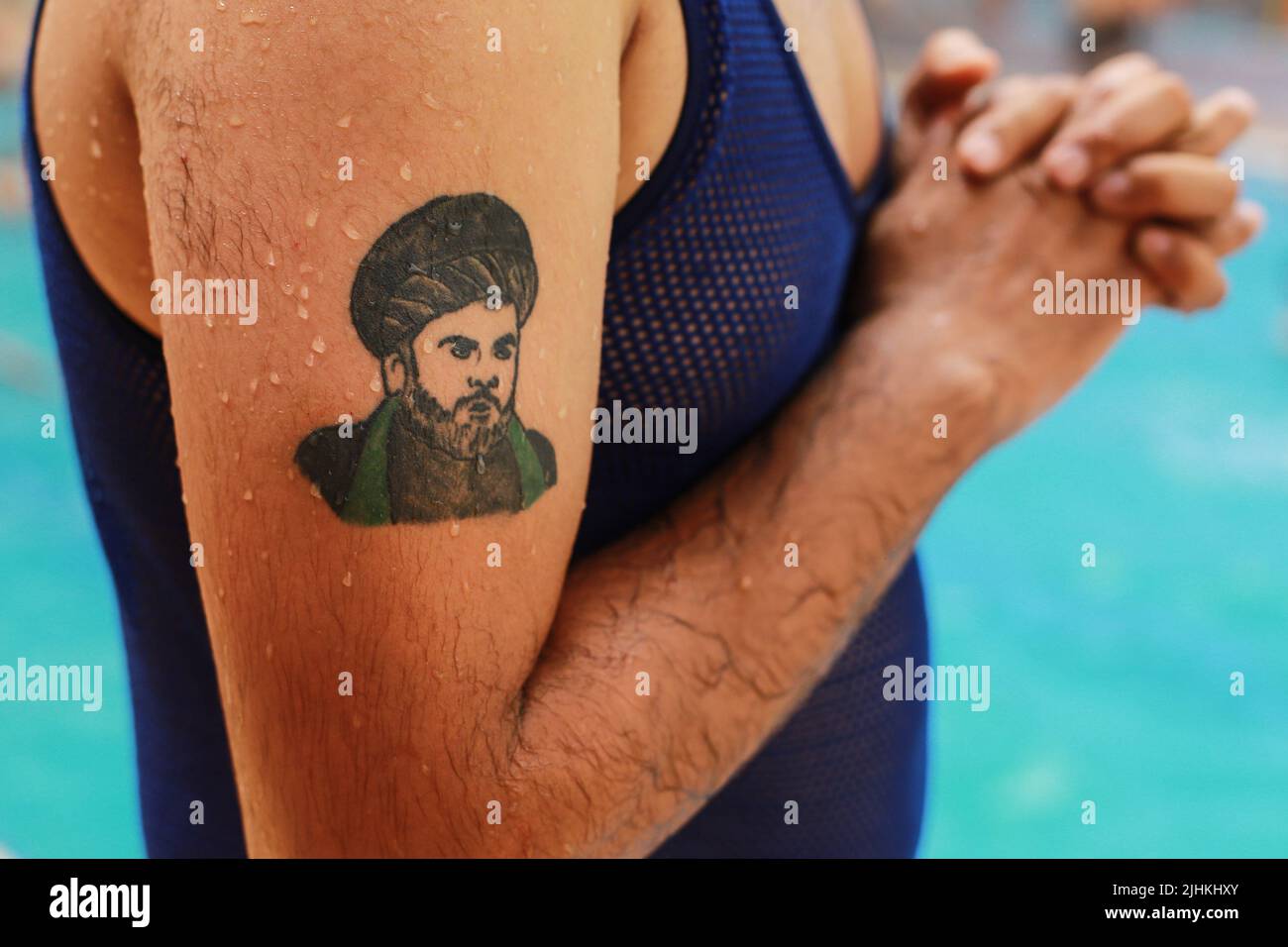 Baghdad, Iraq. 19th July, 2022. An Iraqi man is seen with a portrait of ...