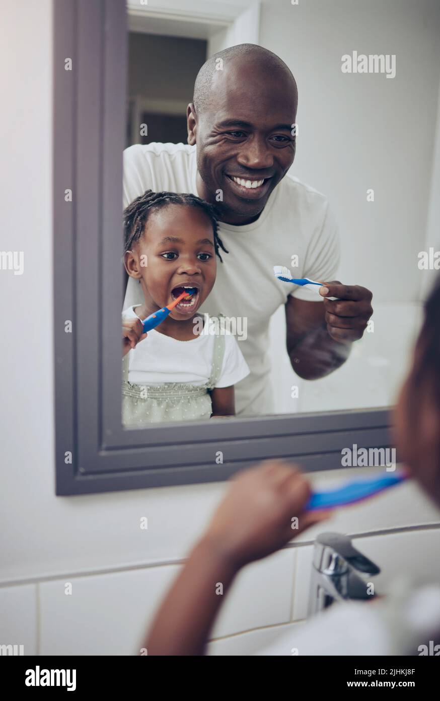 Take your time when you brush. a little girl and her father brushing ...