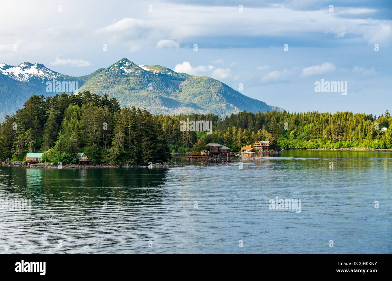 Mountains surrounding the islands of Sitka in Alaska with small homes ...