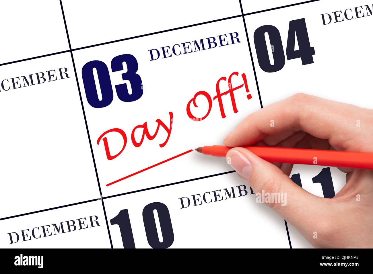 3rd day of December. Hand writing text DAY OFF and drawing a line on ...