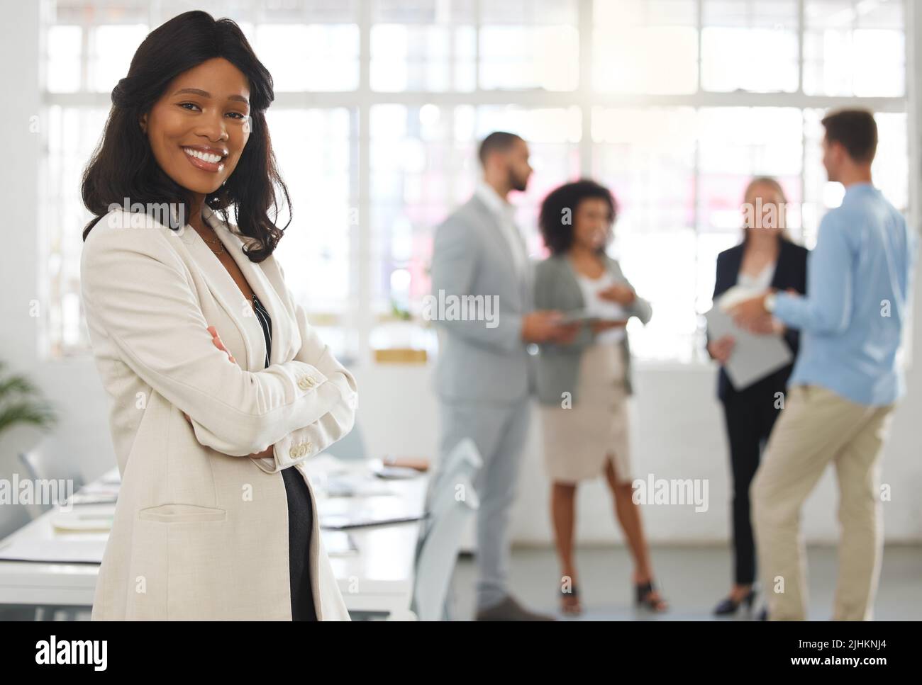 Young happy african american businesswoman standing with her arms ...