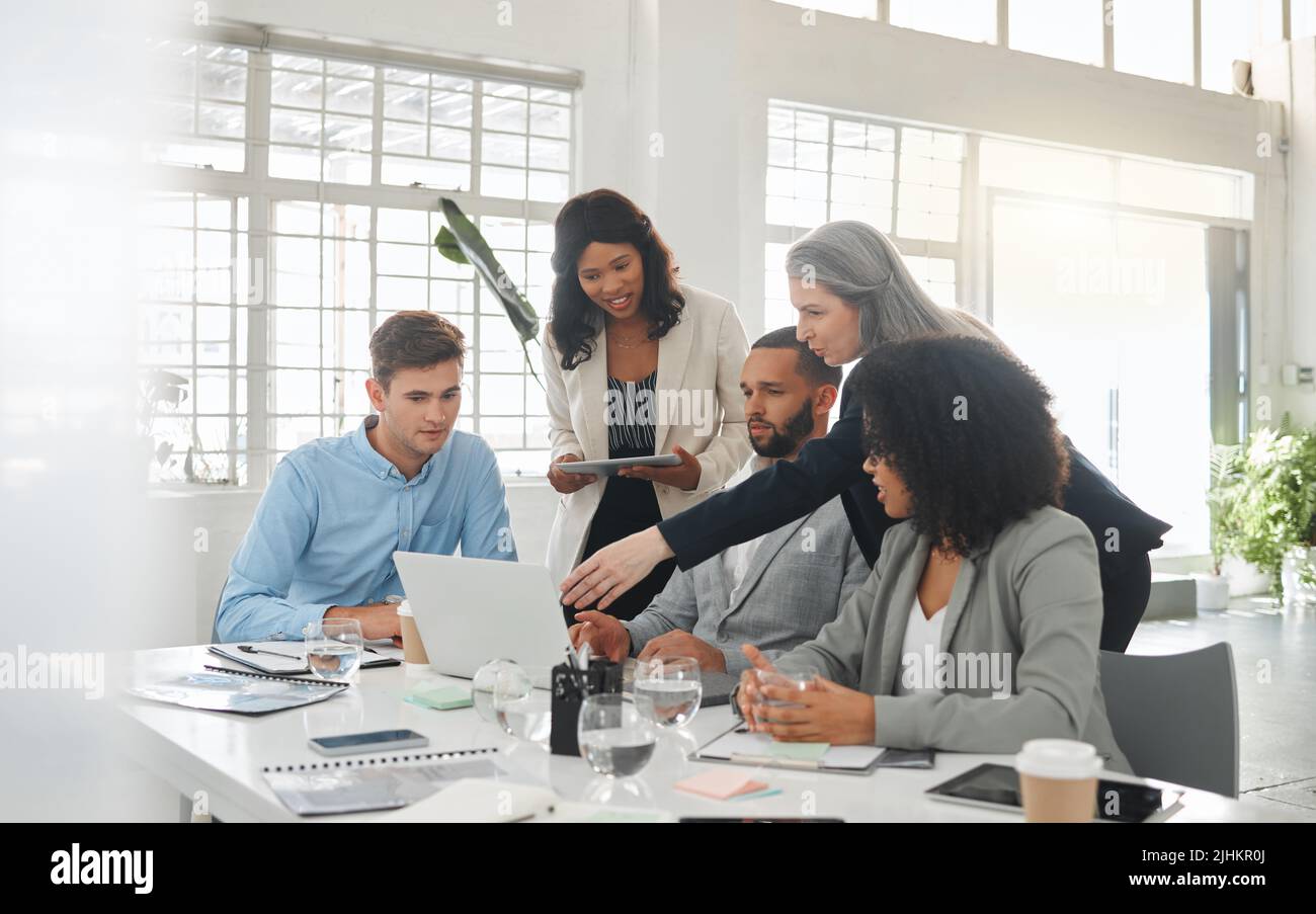 Happy diverse group of businesspeople having a meeting while standing ...