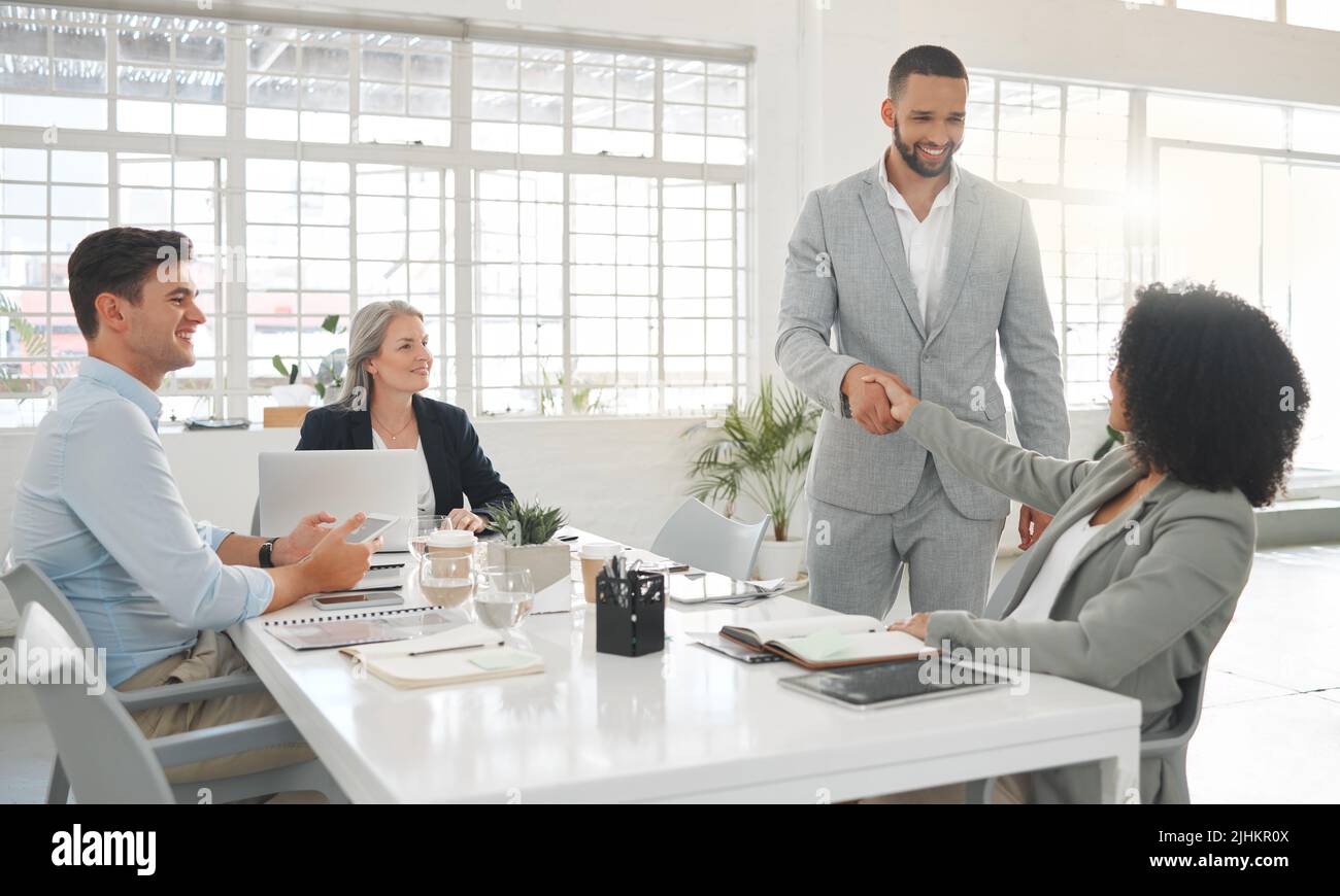 Diverse group of businesspeople having a meeting together at a table at ...