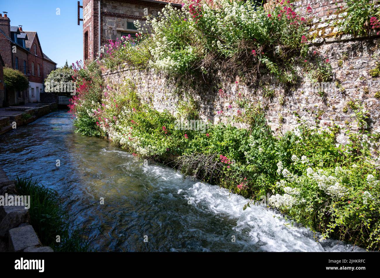 Small river flows throughout beautiful French village Veules-les-Roses ...