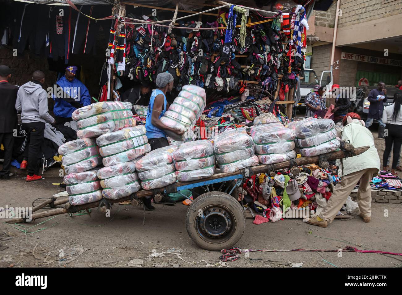A Kenyan man offloads bails second hand clothes (commonly known as ...
