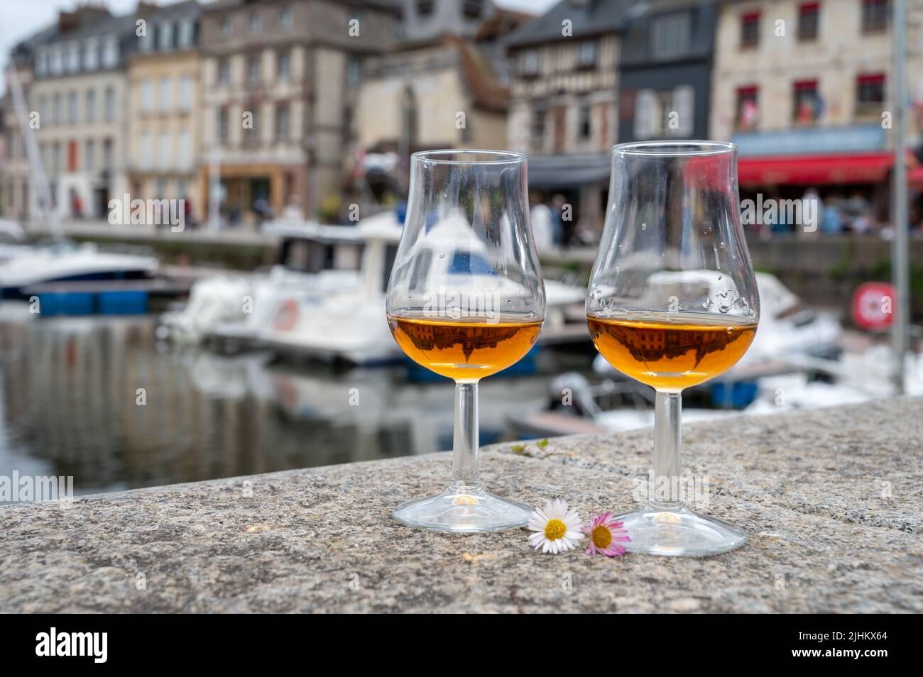 Tasting of apple calvados drink from glasses in old Honfleur harbour ...