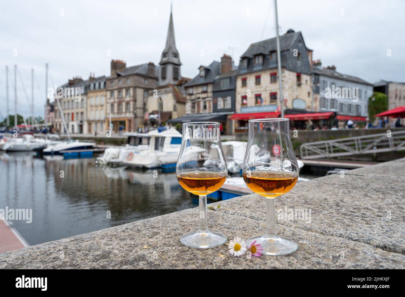 Tasting of apple calvados drink from glasses in old Honfleur harbour ...