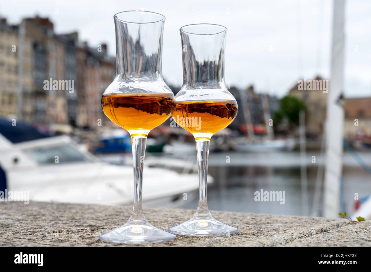 Tasting of apple calvados drink from glasses in old Honfleur harbour ...