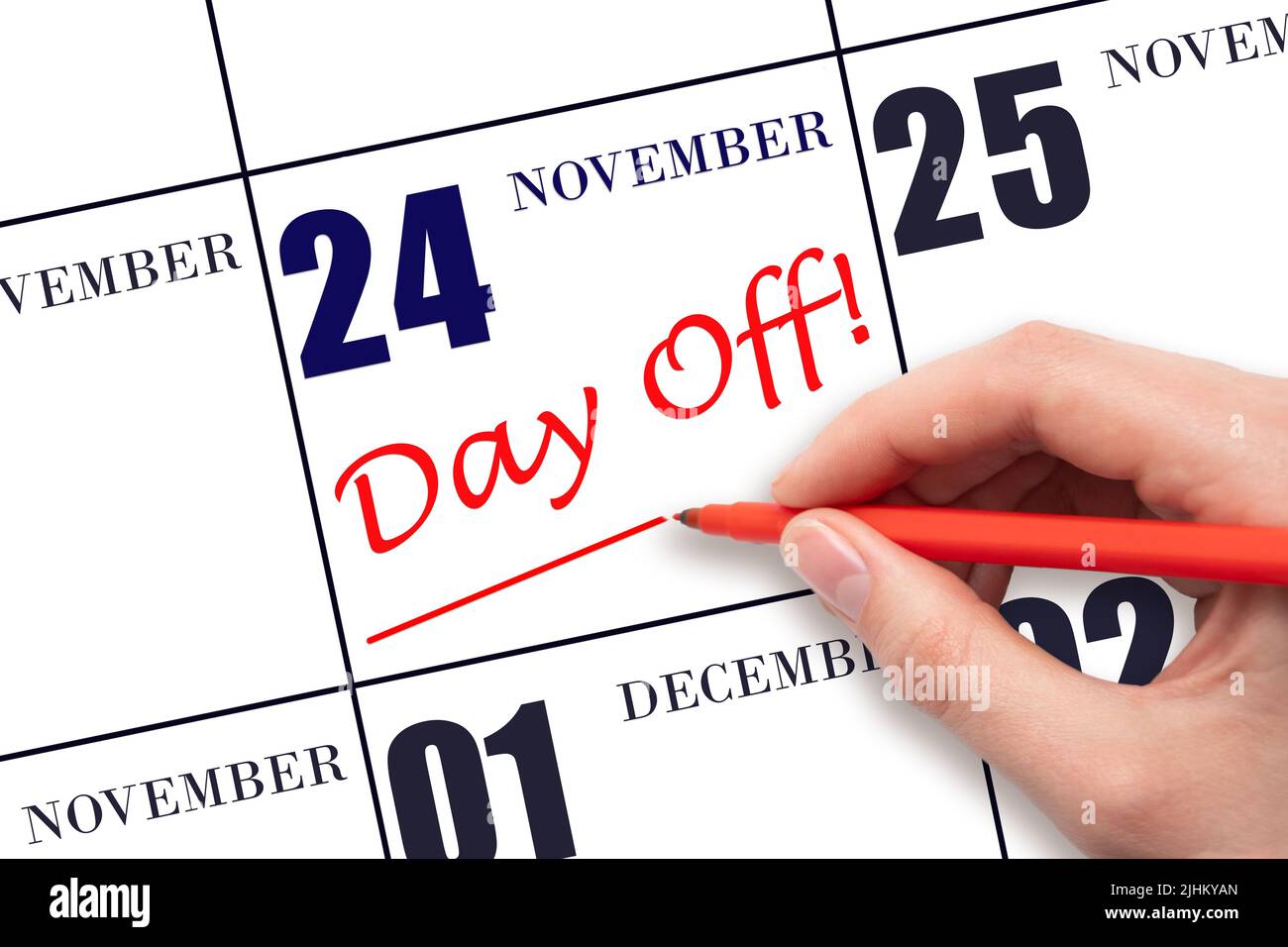 24th day of November. Hand writing text DAY OFF and drawing a line on ...