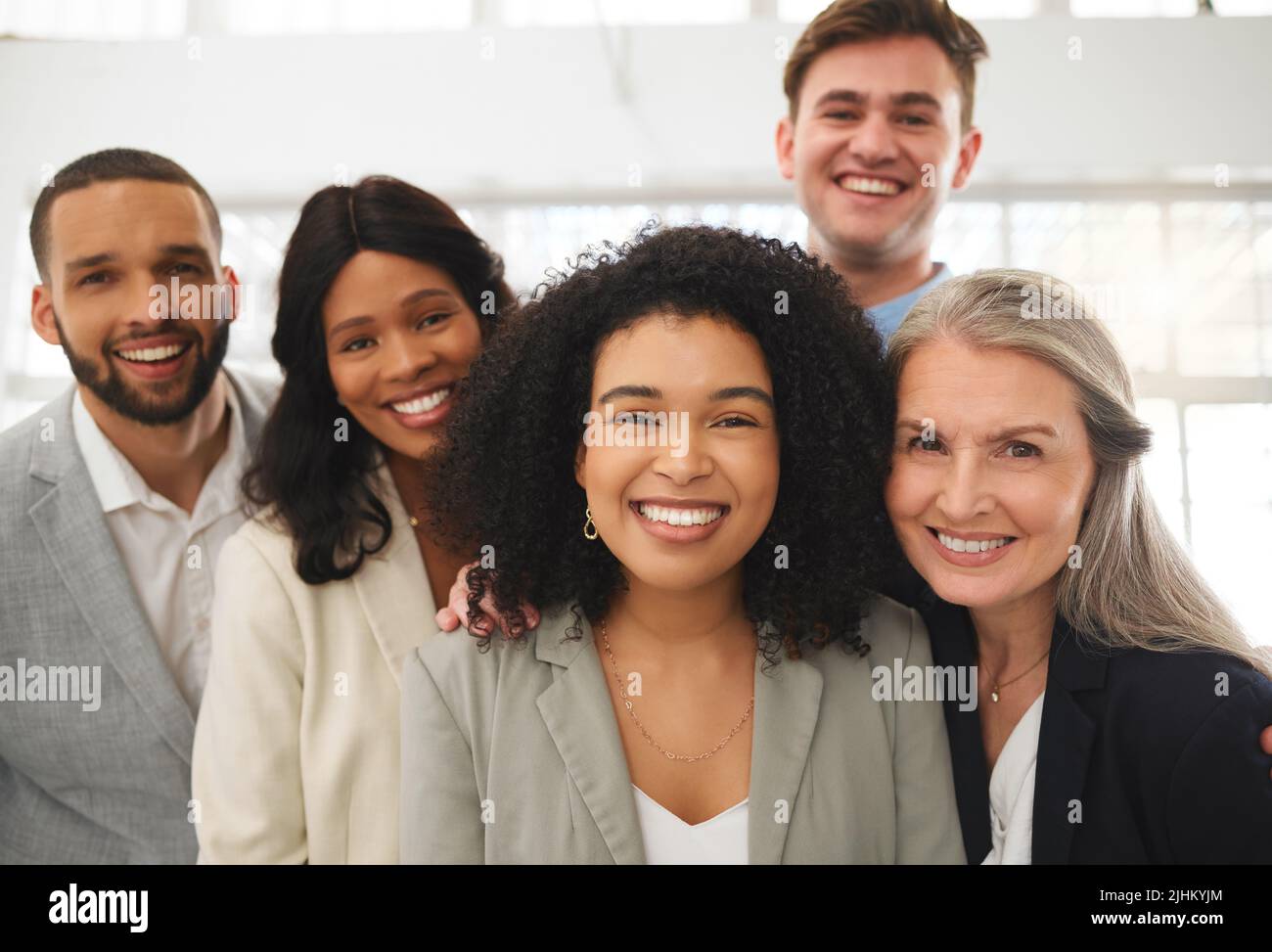 Portrait of a group of happy diverse businesspeople standing together ...