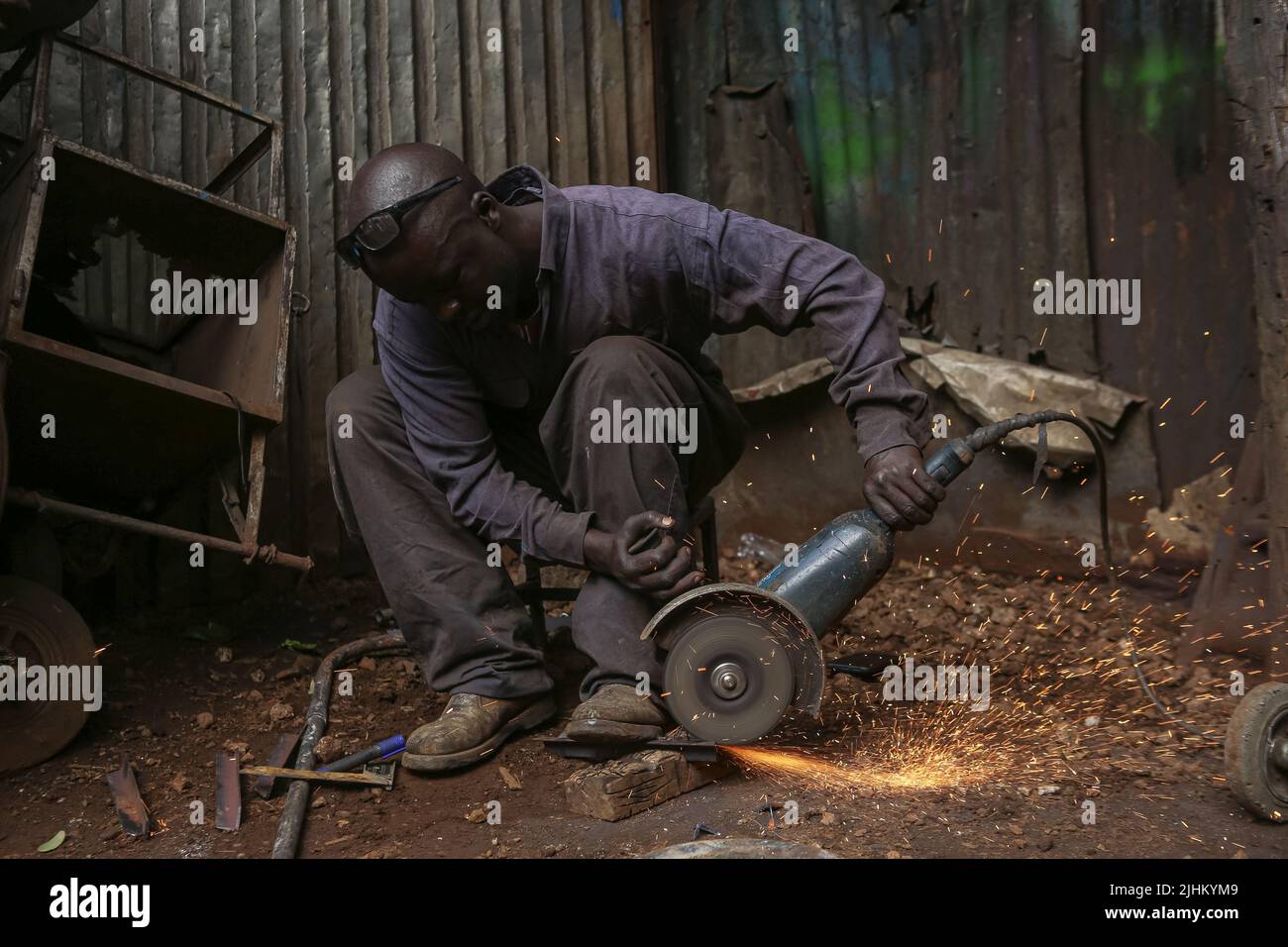 Nairobi, Kenya. 18th July, 2022. A Kenyan welding artisan man (commonly ...