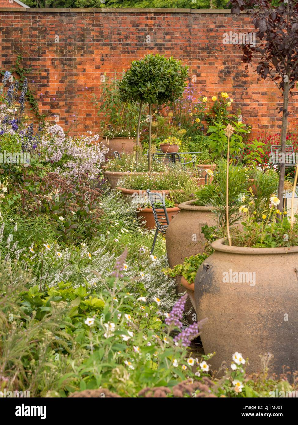 Large urn planters with tables and chairs in between, in the Bee and ...