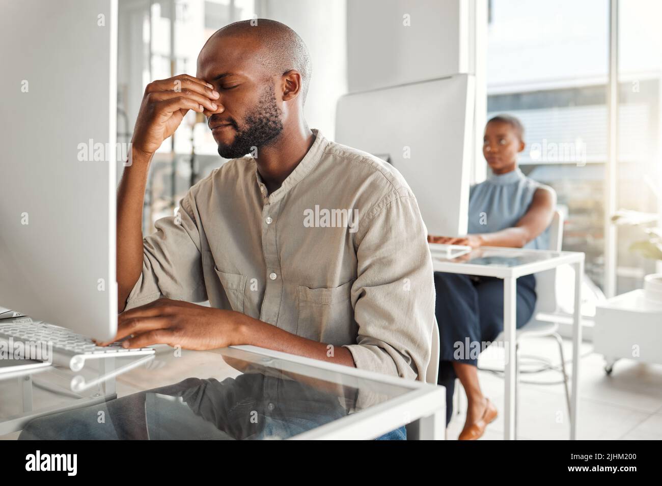 Young stressed african american businessman suffering from a headache ...